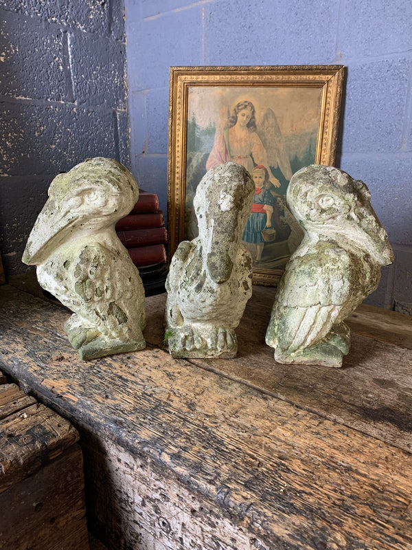 A trio of cast stone pelican statues - Belle and Beast Emporium
