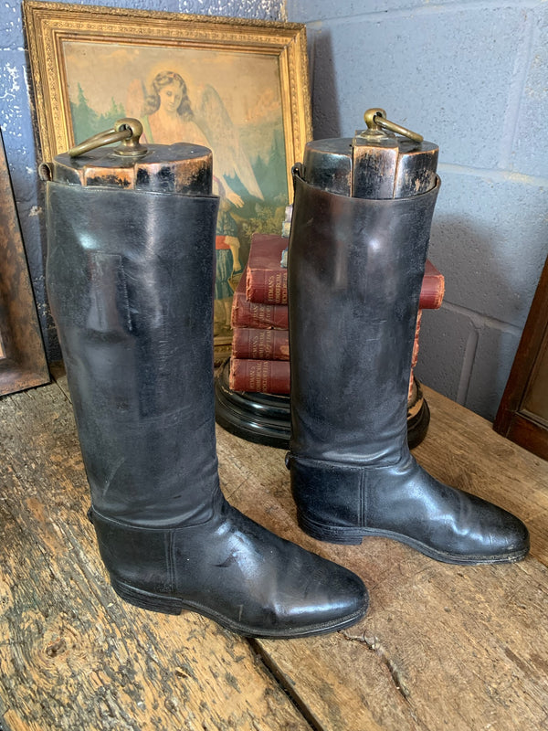 A pair of black leather riding boots with wooden lasts ~ ring pulls ...