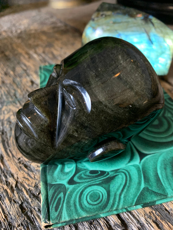 A carved obsidian head - Belle and Beast Emporium