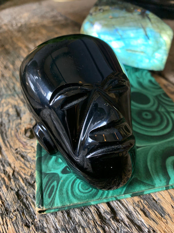 A carved obsidian head - Belle and Beast Emporium