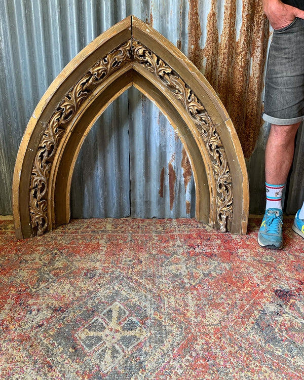 A large carved wooden arch - Belle and Beast Emporium