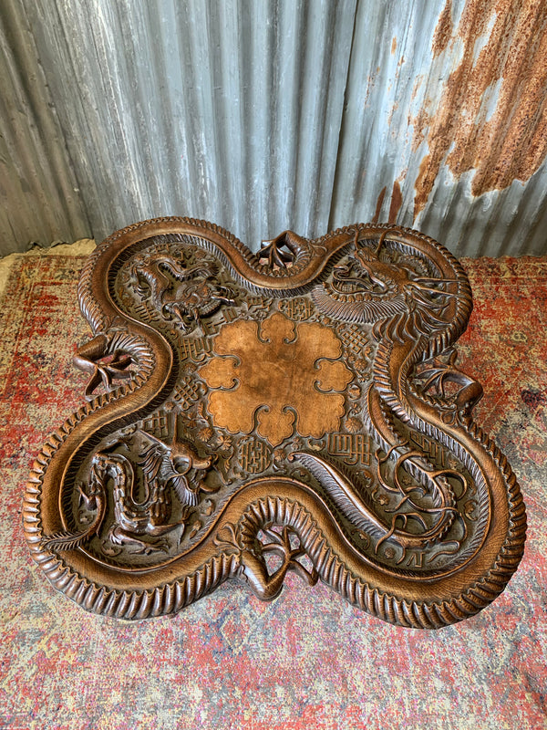 A profusely carved dragon table - Belle and Beast Emporium