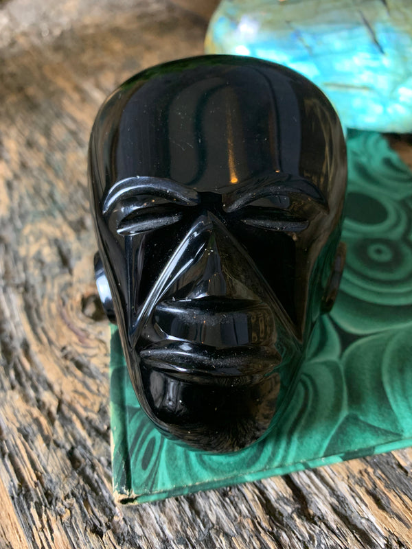 A carved obsidian head - Belle and Beast Emporium