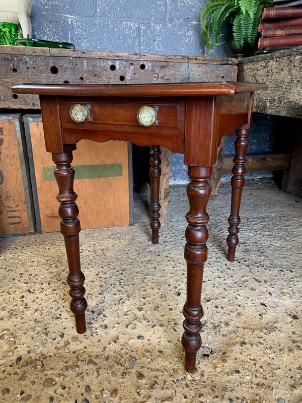 A Victorian single drawer table with ebonised top and glass handles ...
