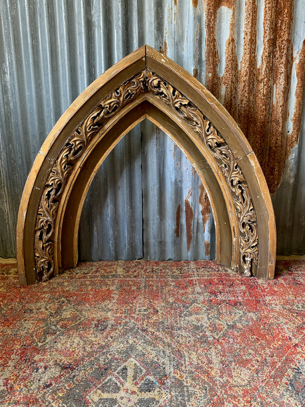 A large carved wooden arch - Belle and Beast Emporium